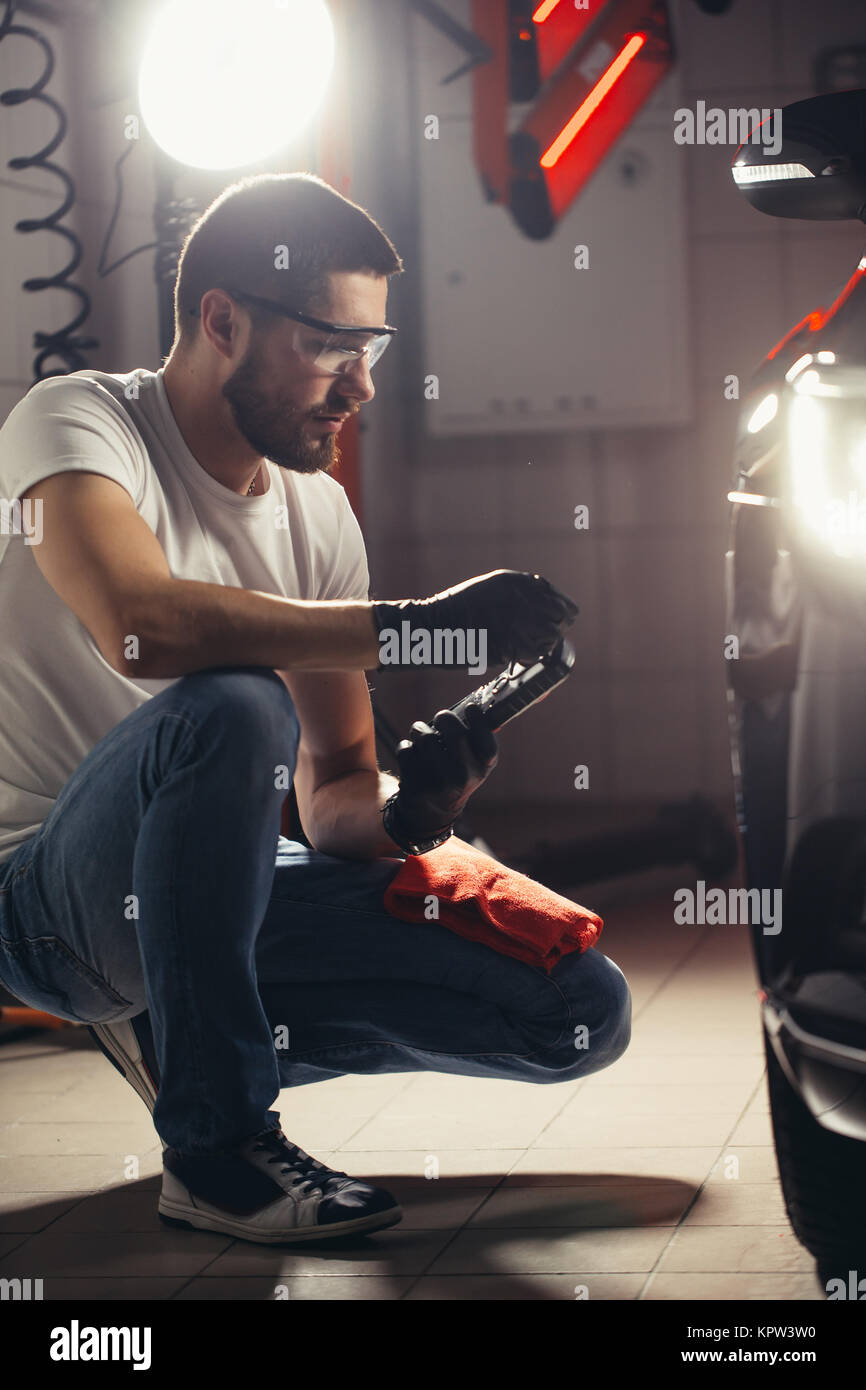 man checks polishing with a torch Stock Photo - Alamy