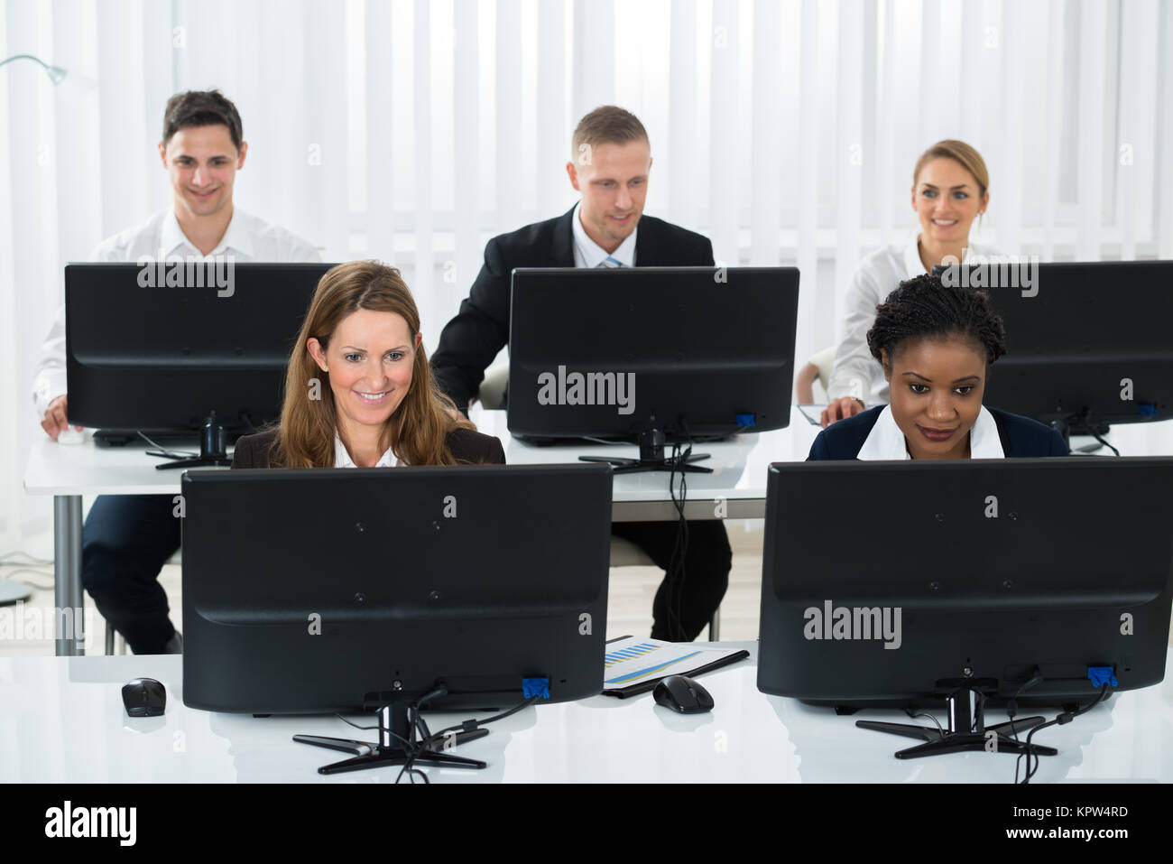 Businesspeople Working On Computers Stock Photo - Alamy