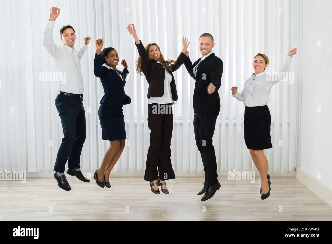 Businesspeople Jumping In Joy Stock Photo - Alamy