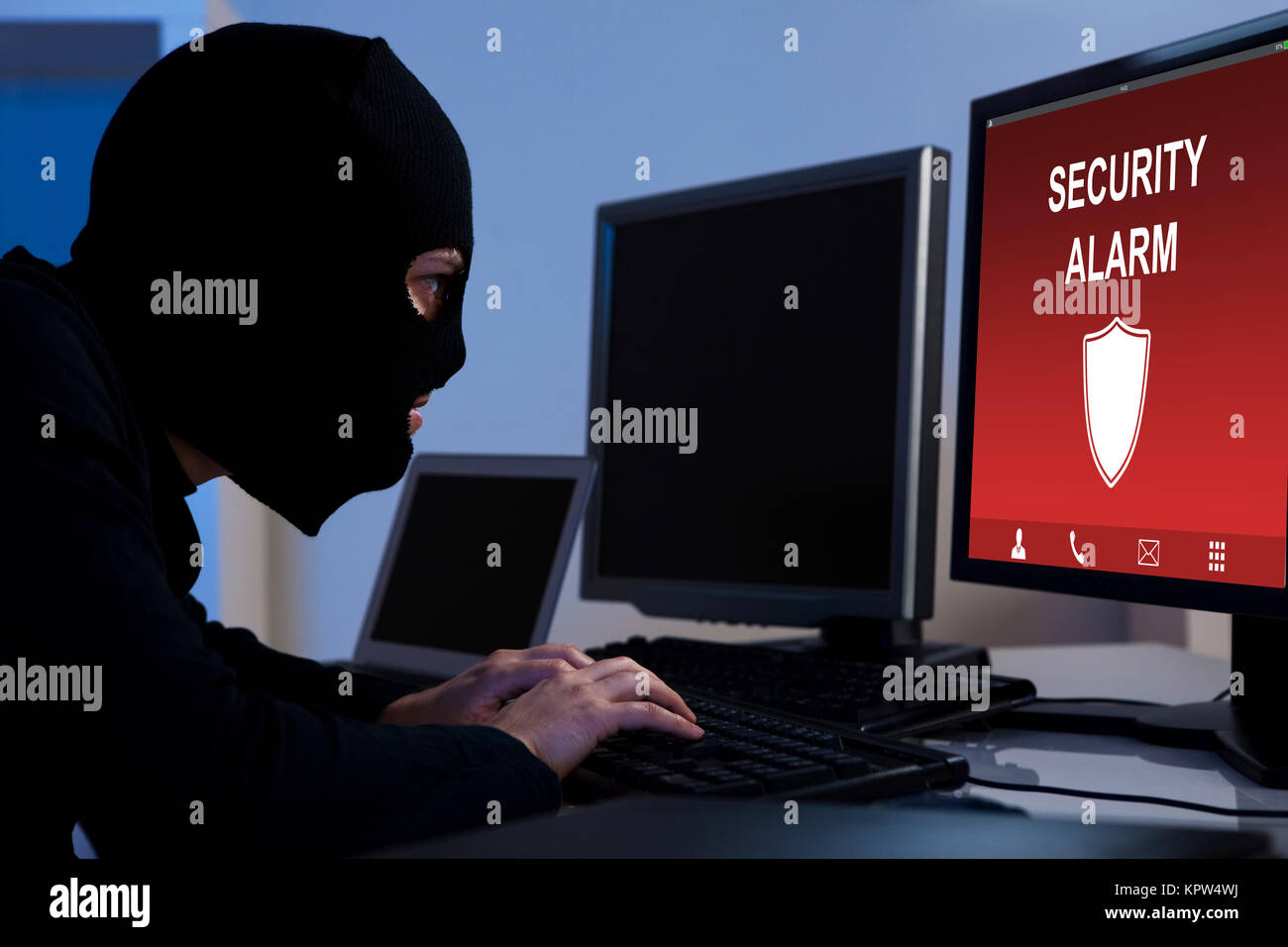 Hacker downloading information off a computer Stock Photo - Alamy