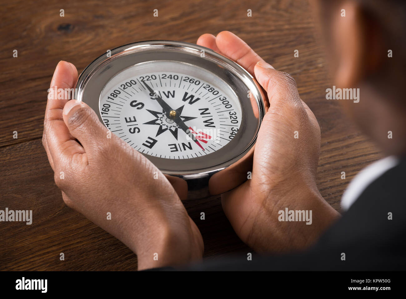 Businessperson Hand Holding Compass Stock Photo - Alamy