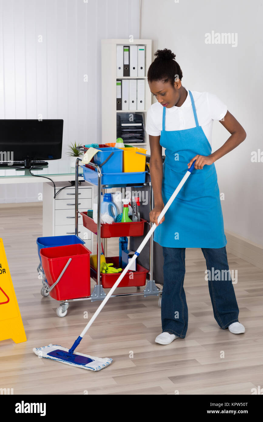 Female Worker Cleaning Floor In Office Stock Photo - Alamy