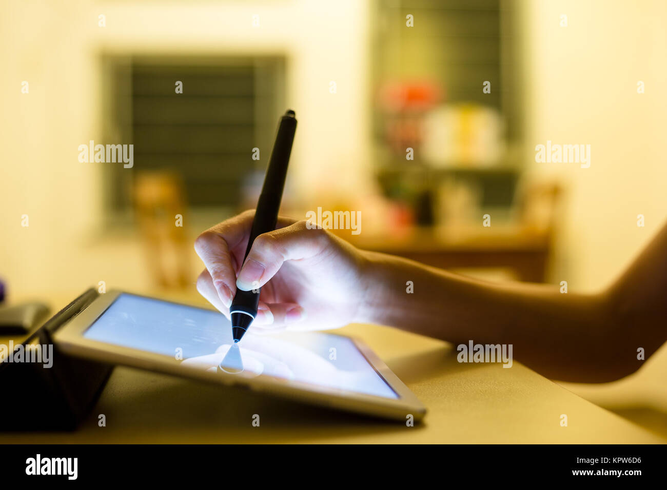 Woman write on tablet pc Stock Photo - Alamy