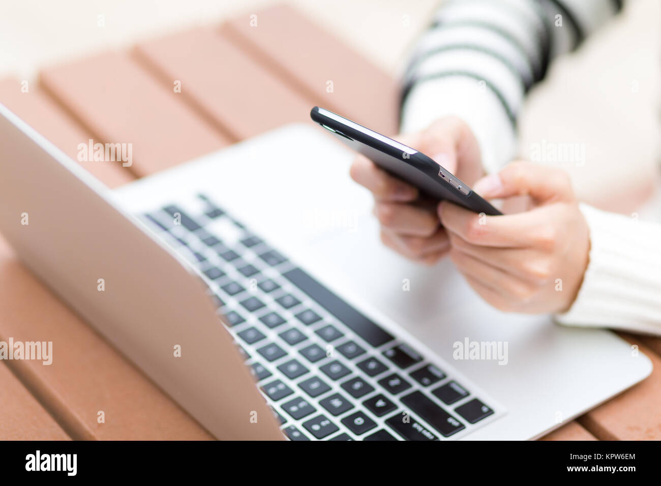 Woman use of laptop computer and cellphone Stock Photo - Alamy