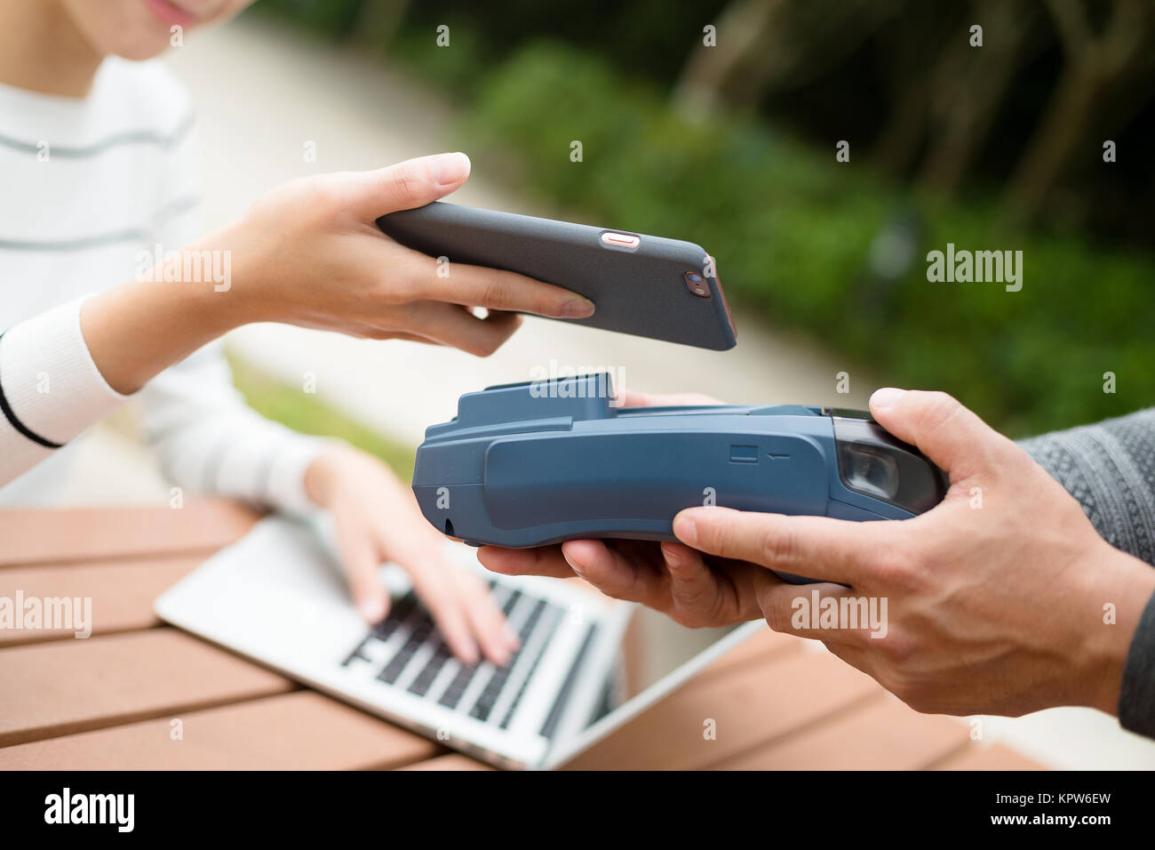 Woman pay on pos machine Stock Photo - Alamy