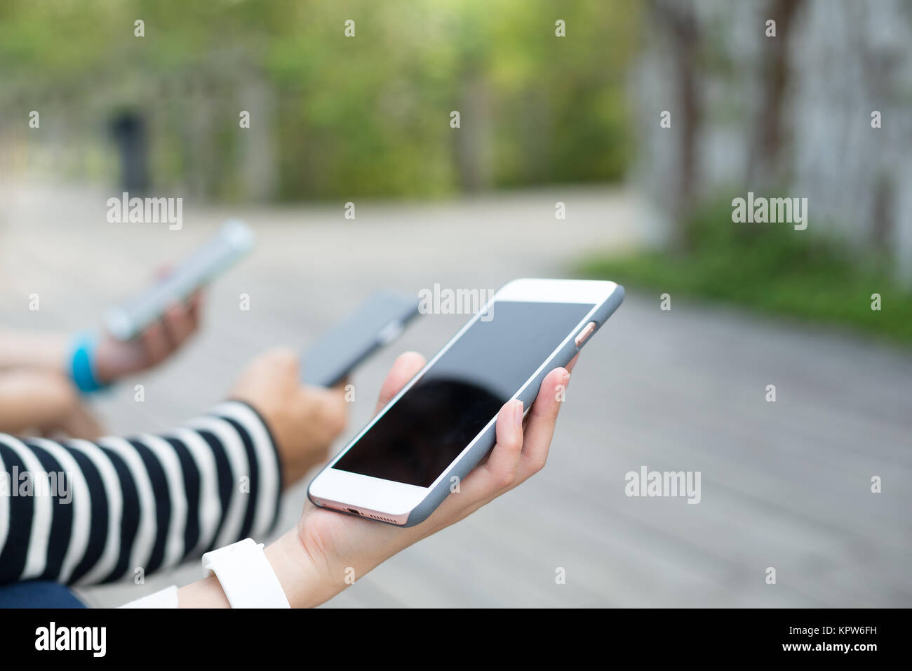 Group of people using cellphone together Stock Photo - Alamy