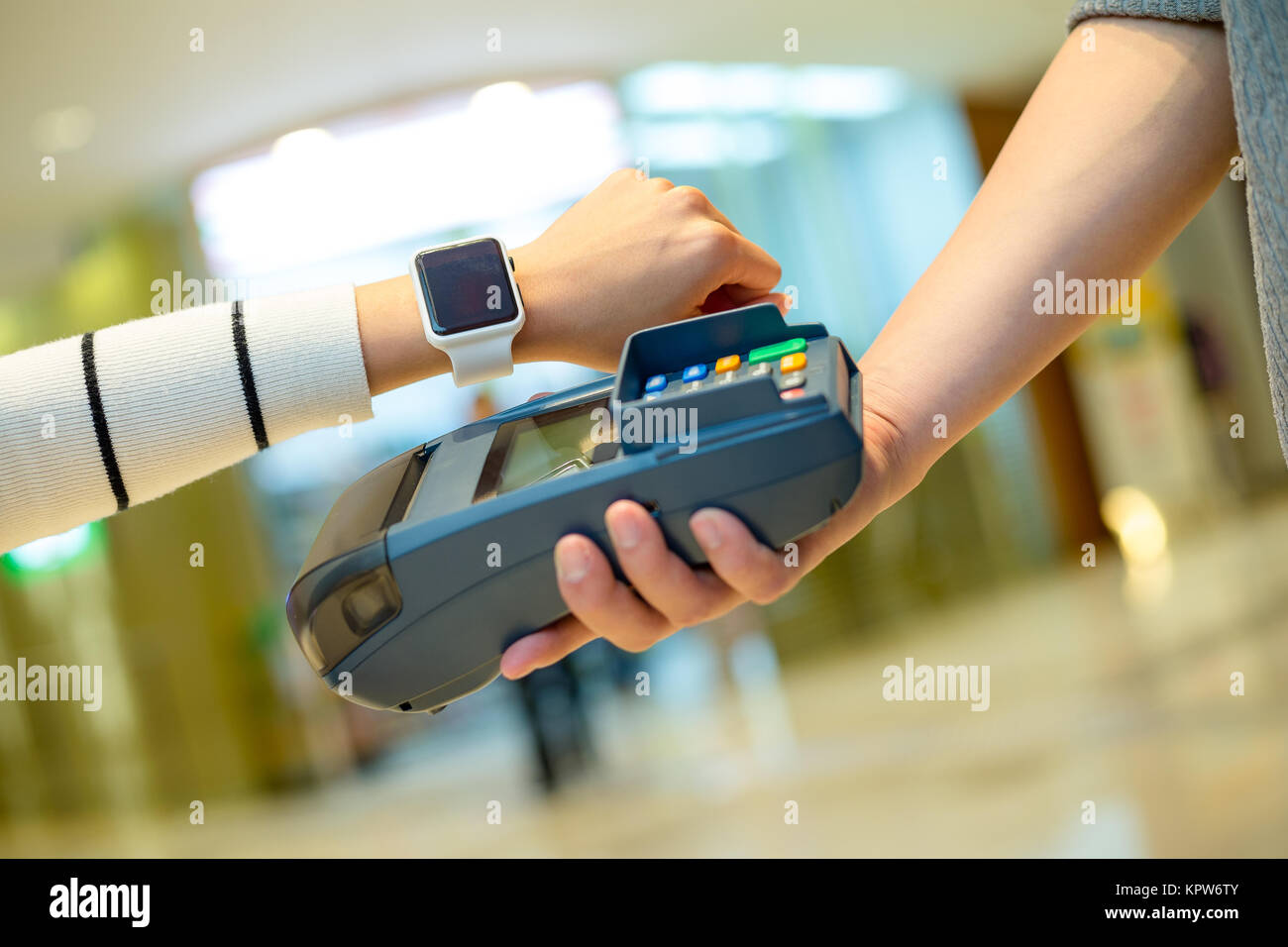 Customer using smart watch to pay Stock Photo - Alamy