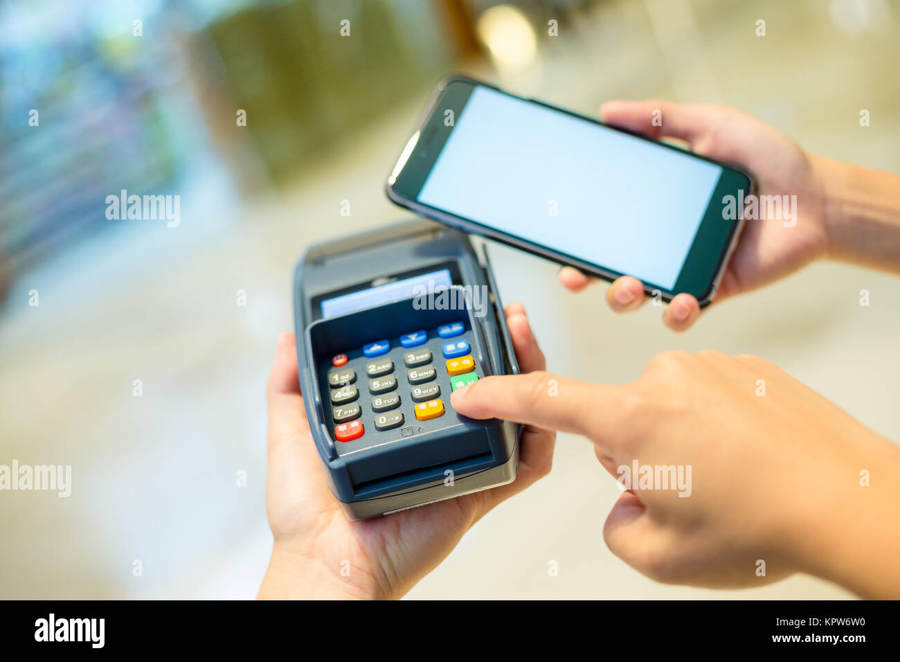 Customer using cellphone for pay on pos machine Stock Photo - Alamy