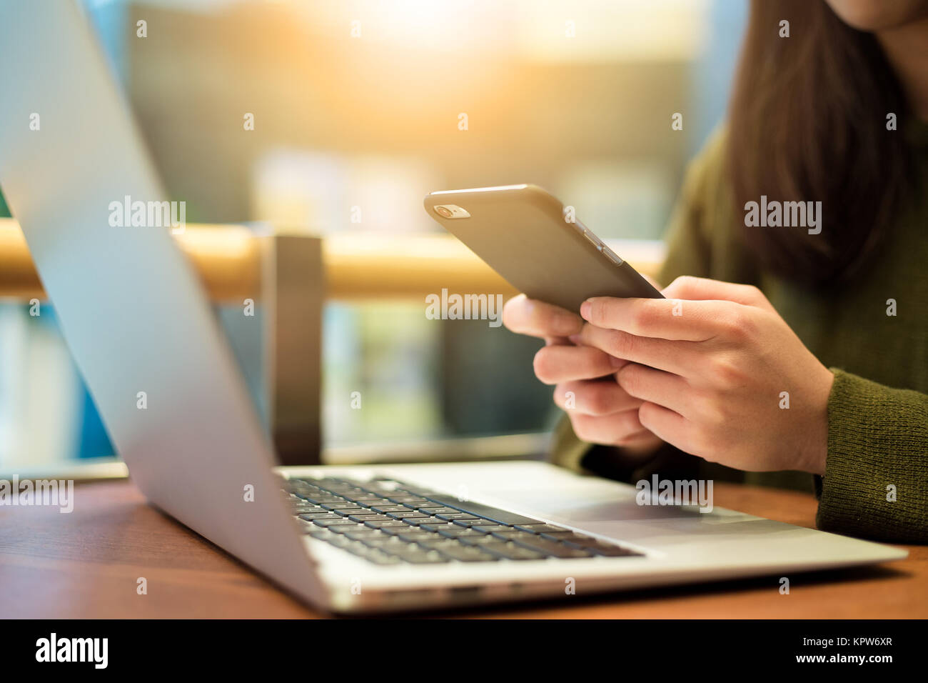 Woman use of cellphone and laptop computer Stock Photo - Alamy