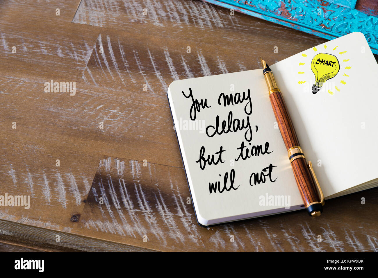 Handwritten text You May delay, But Time Will Not Stock Photo - Alamy