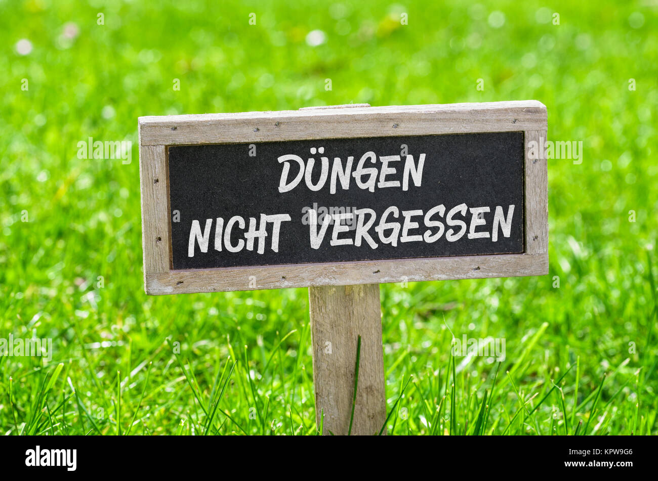 do not forget fertilizing - sign in the lawn Stock Photo - Alamy