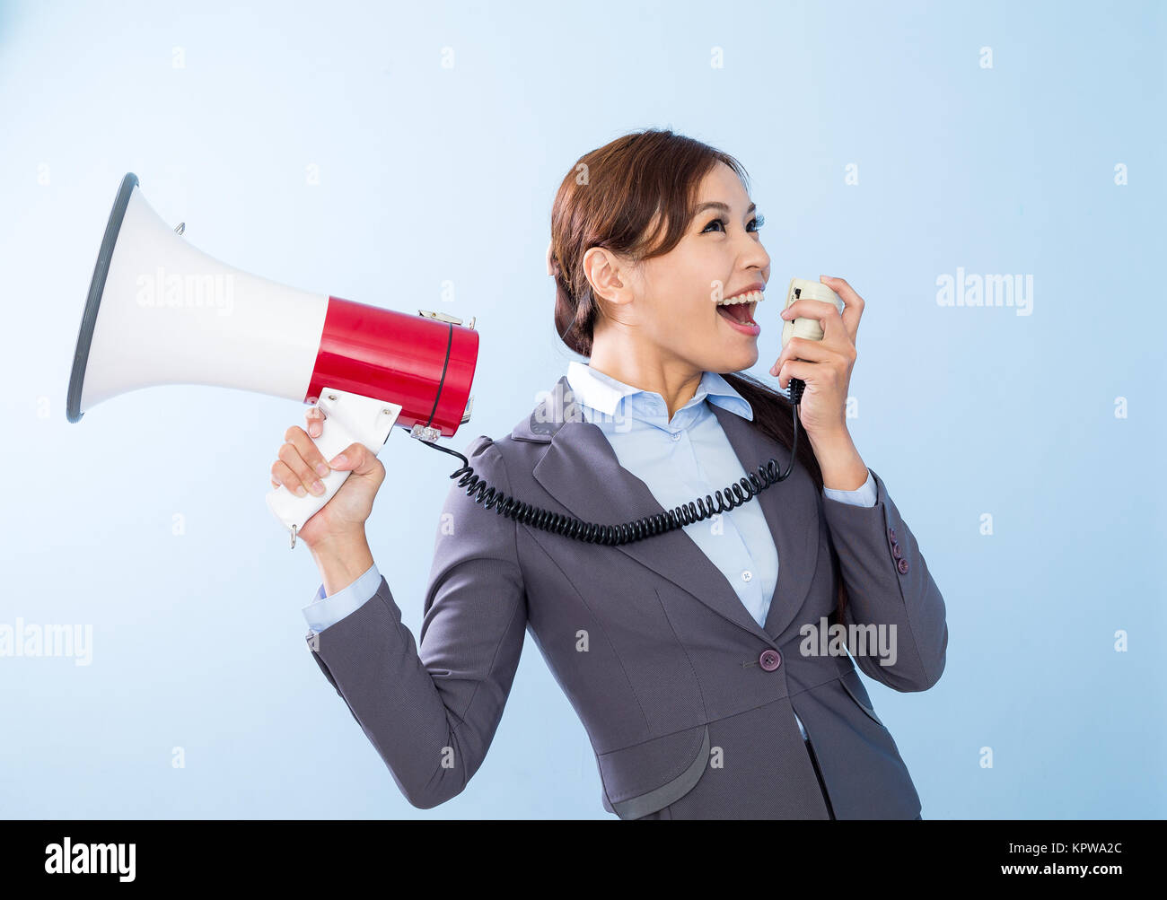 Businesswoman shouting with loudspeaker Stock Photo - Alamy