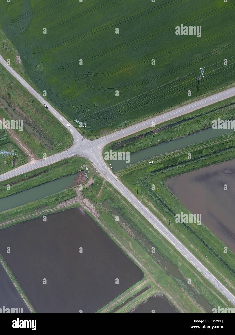 Crossroads paved roads through the fields Stock Photo - Alamy