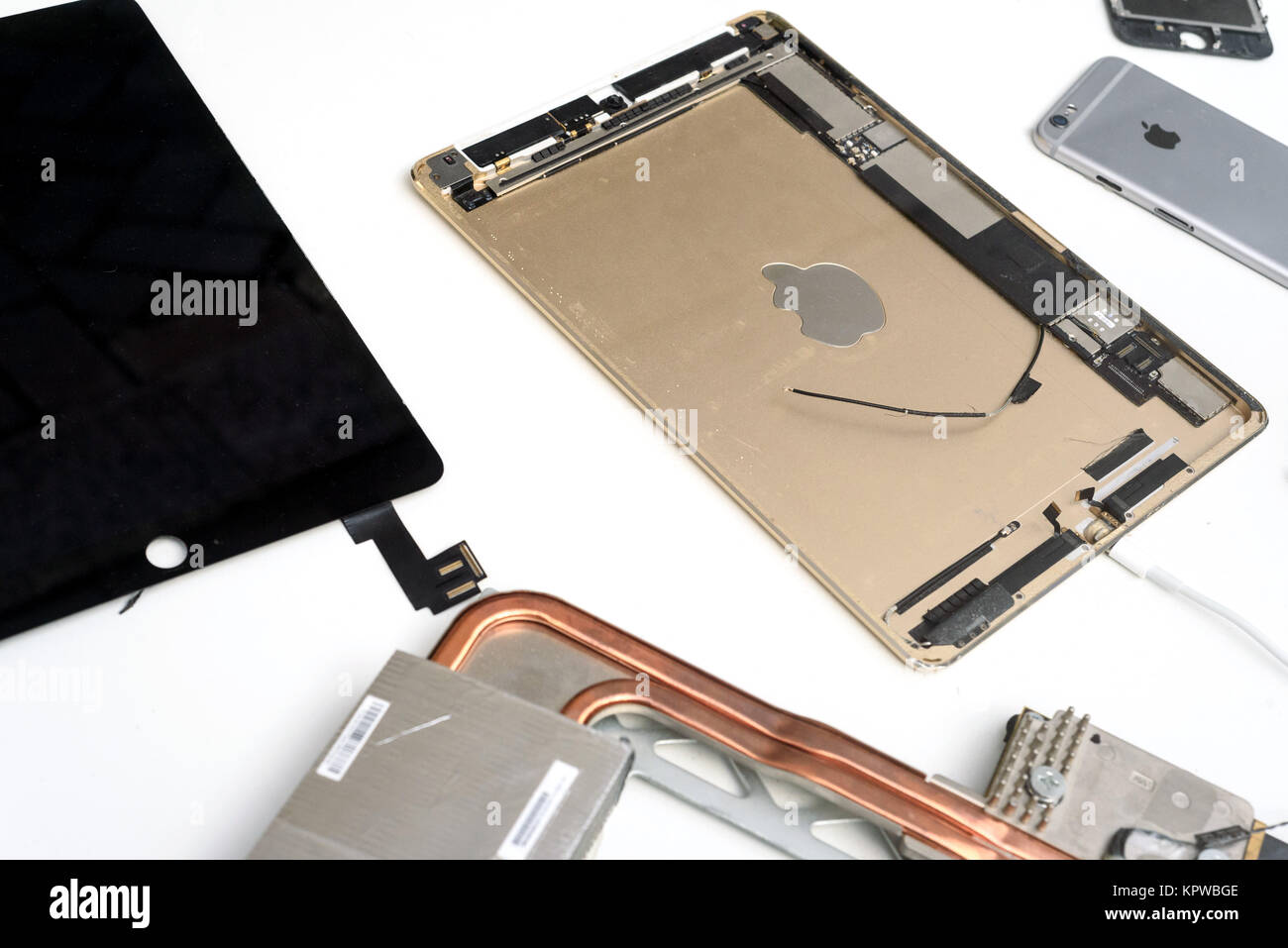 Broken components of an apple macbook ipad computer on a white ...