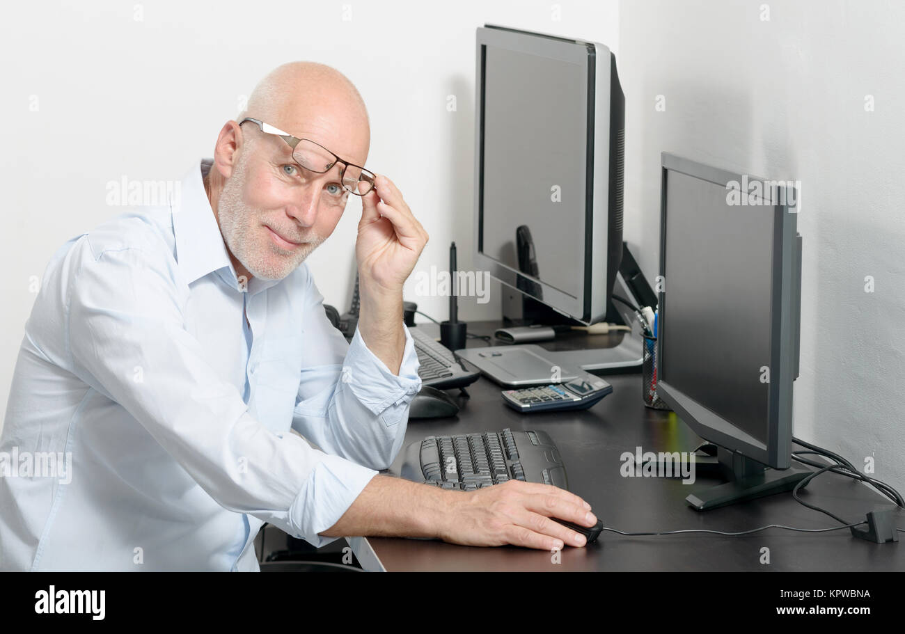 mature man working with his computer Stock Photo - Alamy