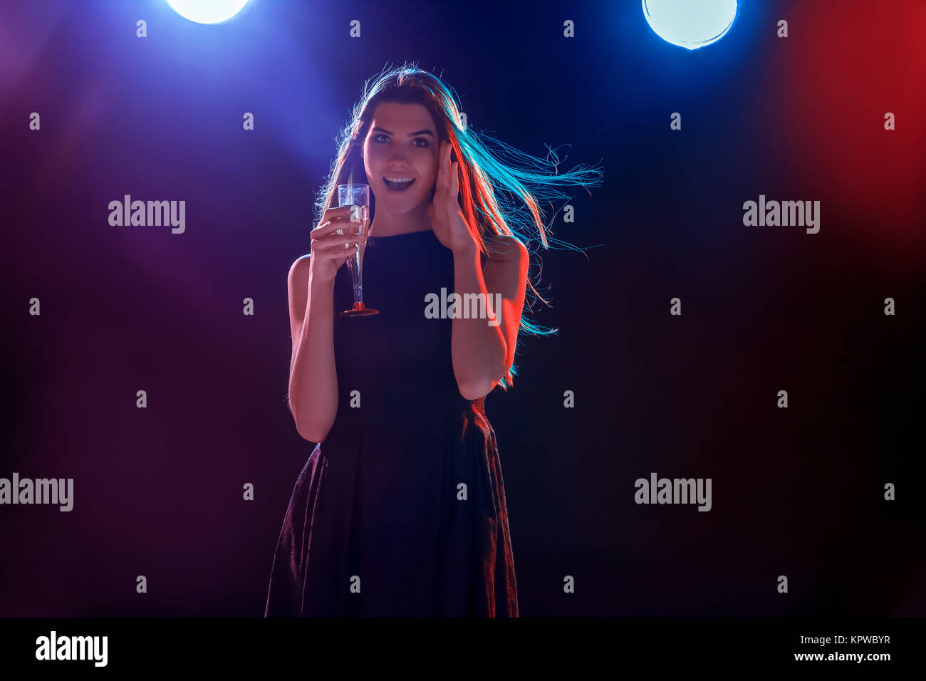 The beautiful girl dancing at the party drinking champagne Stock Photo ...