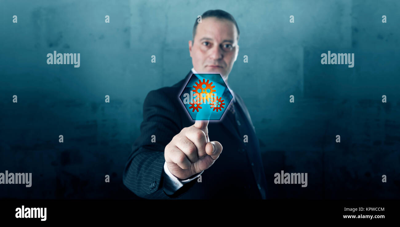 Entrepreneur Pressing Push Button With Cog Wheels Stock Photo - Alamy
