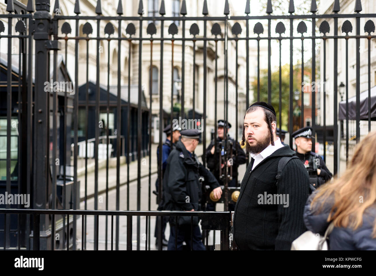 Jewish tourist poses outside of 10 Downing Street with armed police ARU ...