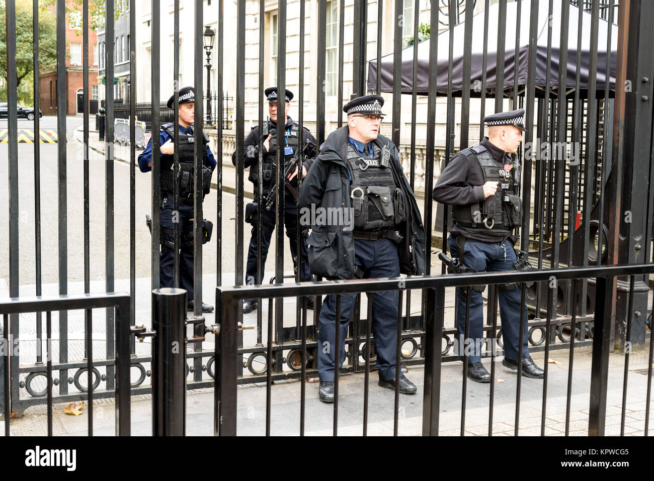 Armed police officers outside the gates of 10 Downing Street in London ...