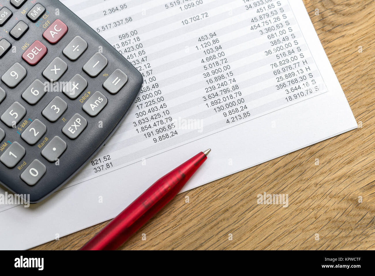 Accounting paper lying on wooden table with calculator as closeup Stock ...