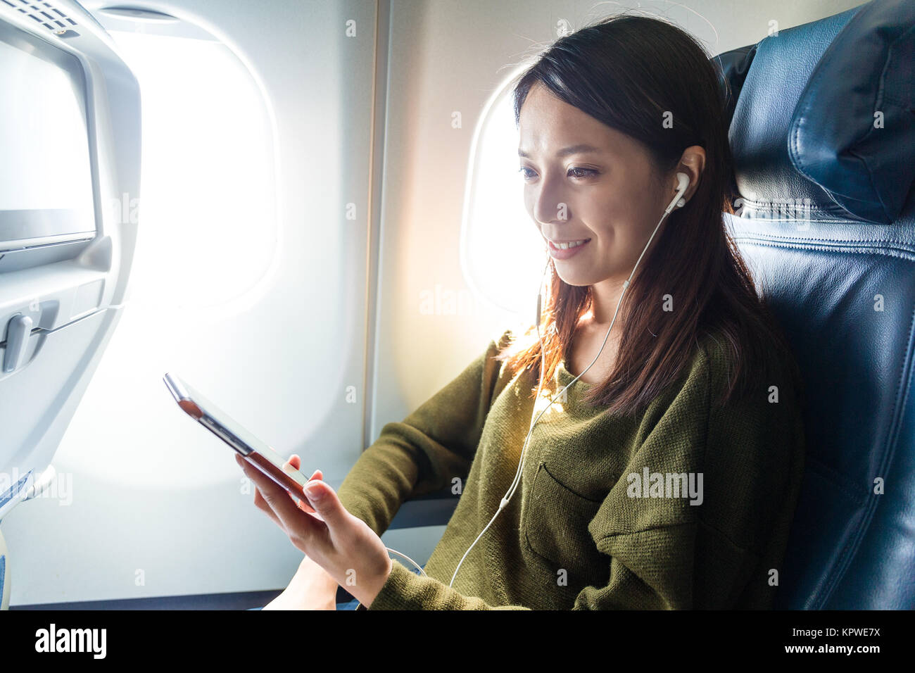 Women using technology in plane hi-res stock photography and images - Alamy