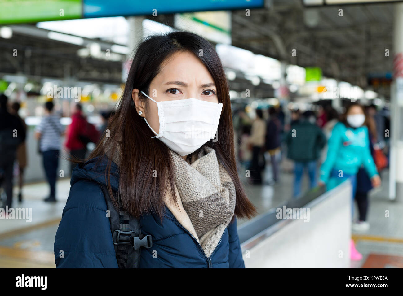 Woman wearing face mask in train station Stock Photo - Alamy