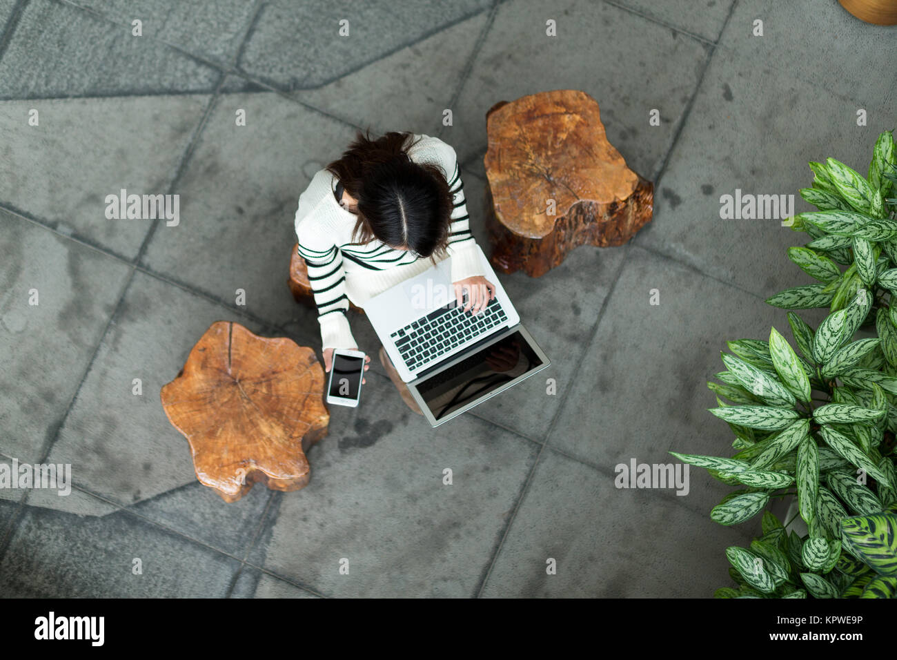 top view of woman using laptop computer and smart phone Stock Photo - Alamy