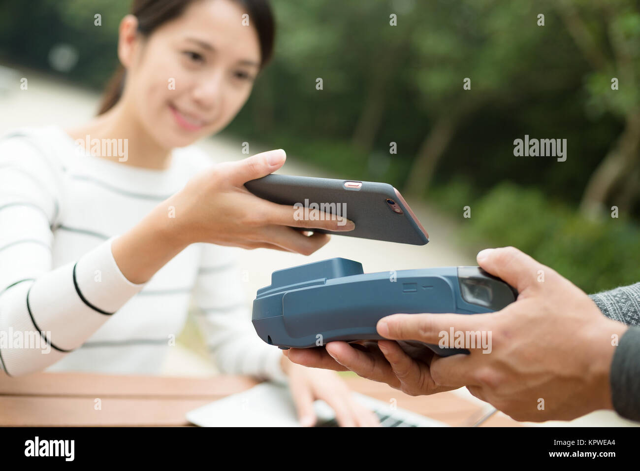 Woman pay with cellphone by NFC technology Stock Photo - Alamy