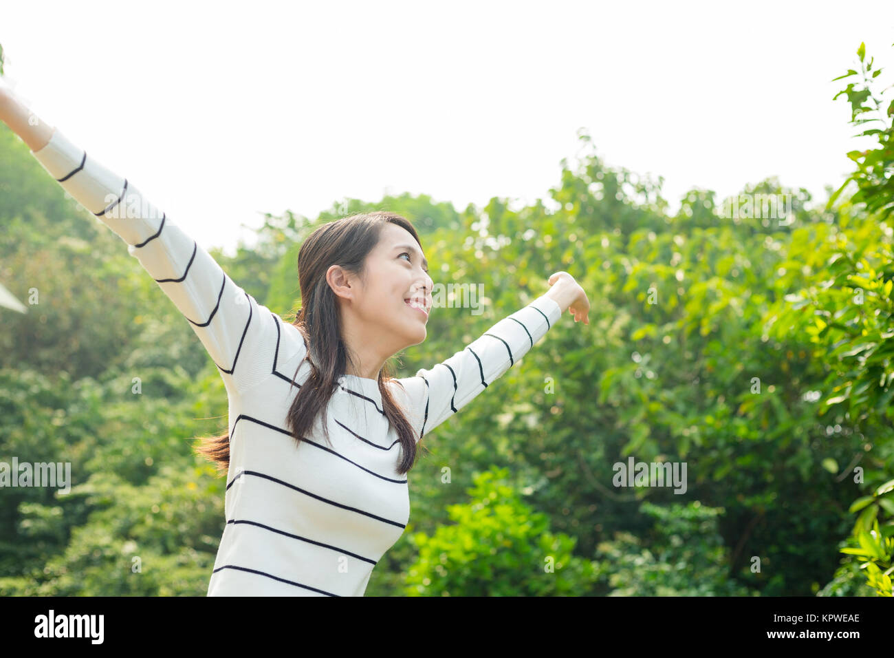 Woman outstretched her hand in the park Stock Photo - Alamy