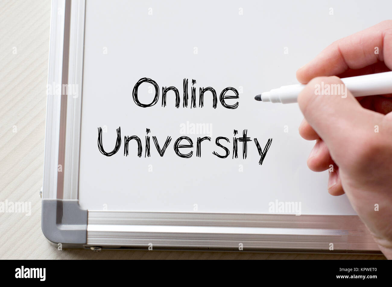 Online university written on whiteboard Stock Photo - Alamy