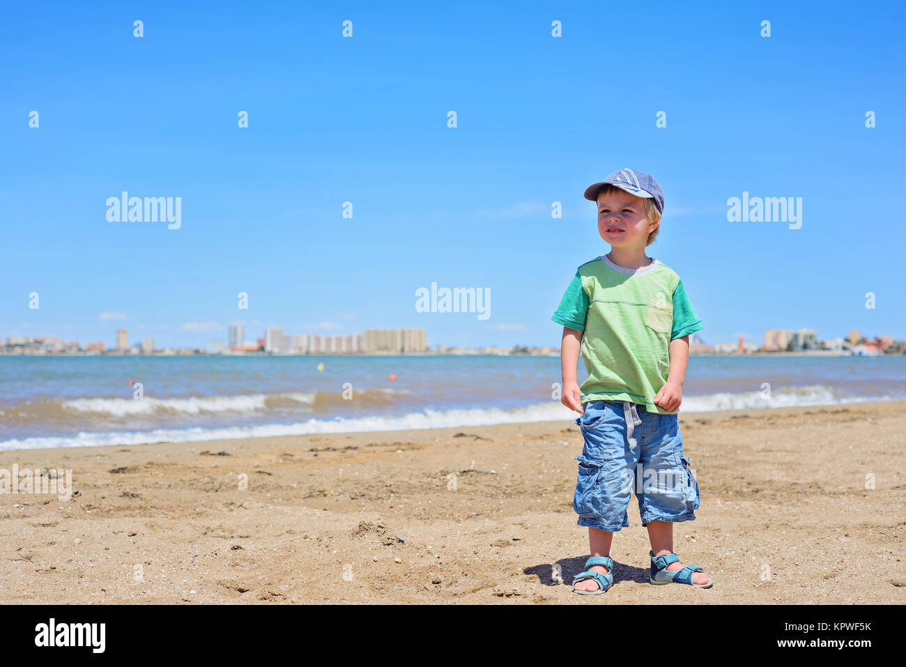Cute small boy standing on the beach Stock Photo - Alamy