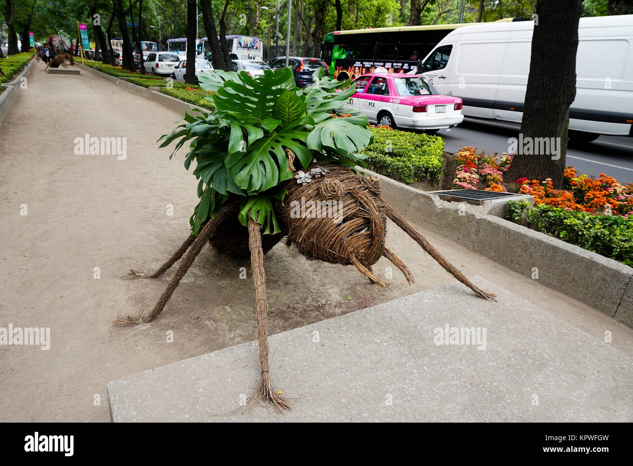 Straw insects and plant topiary outside the Jardín Botánico del Bosque ...