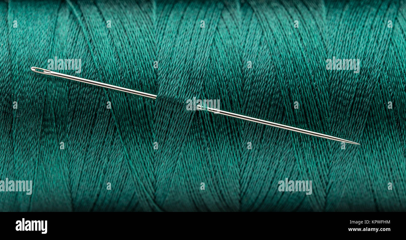 Thread with needle Stock Photo - Alamy