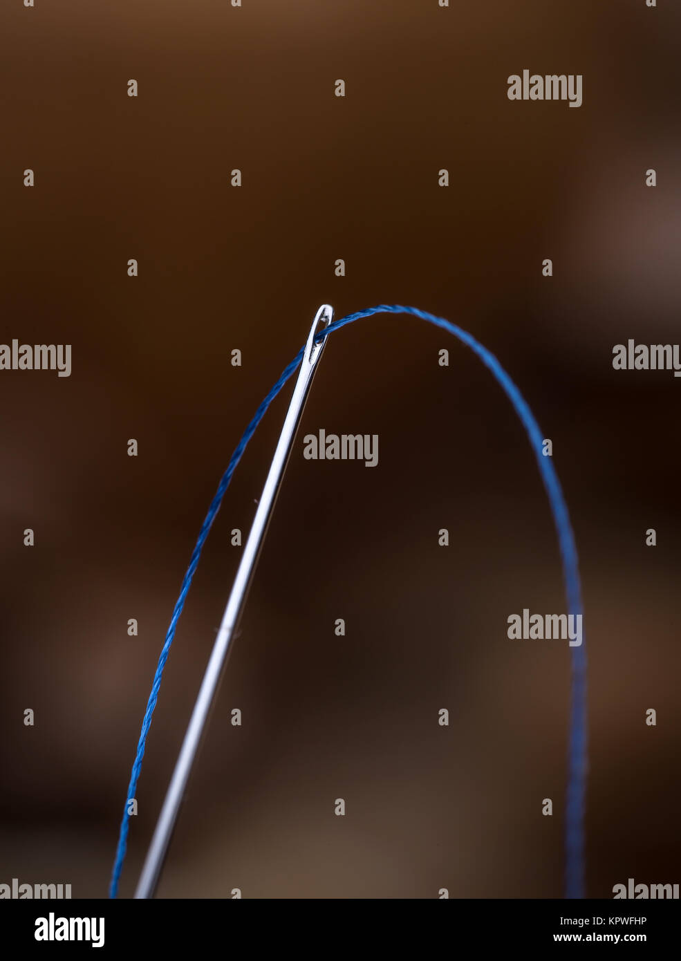 Blue thread and needle Stock Photo - Alamy