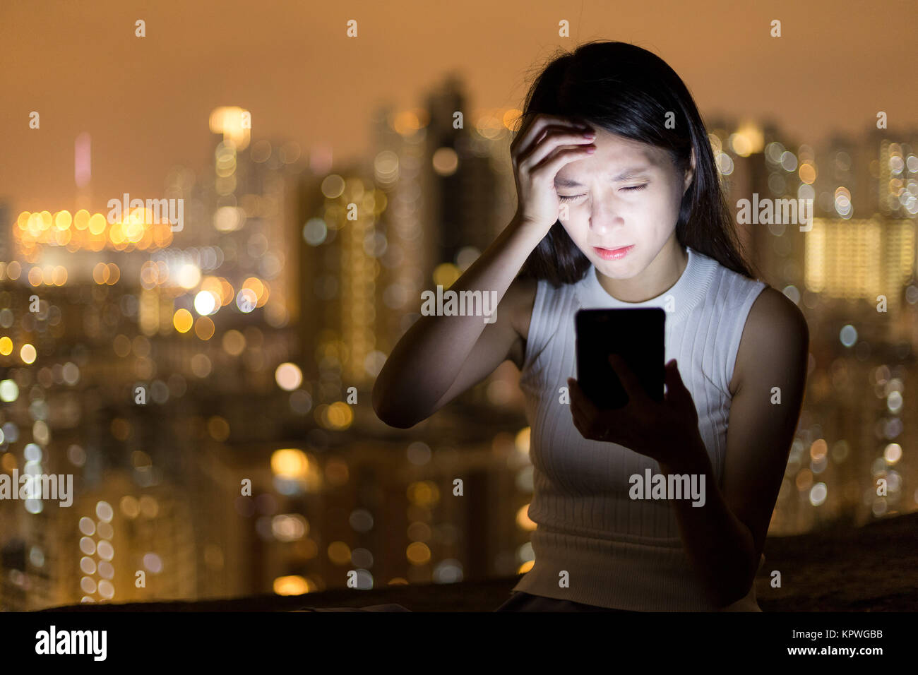 Woman suffer from headache when use of mobile phone at night Stock ...