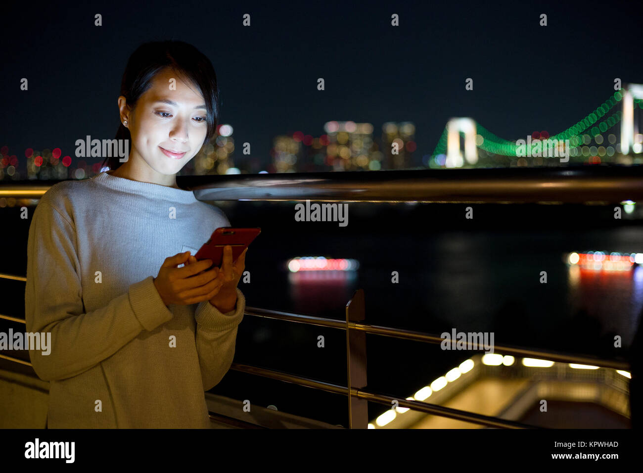 Woman use of cellphone at outdoor Stock Photo - Alamy