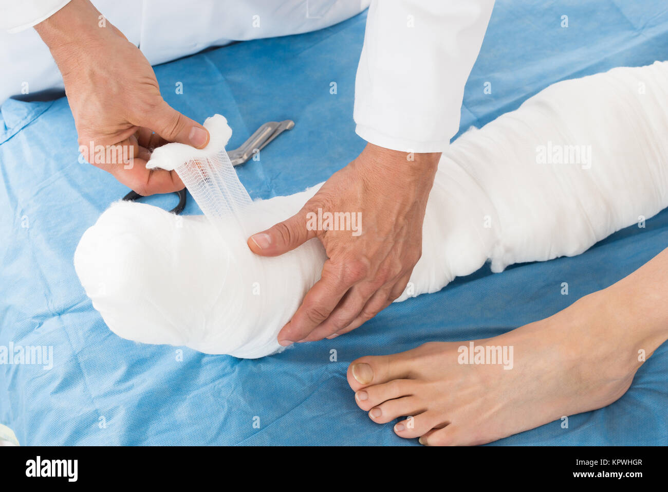 Doctor Tying Bandage On Patient Leg Stock Photo - Alamy