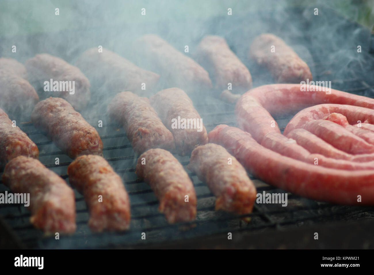 Barbecuing meat on charcoal fire closeup image Stock Photo - Alamy