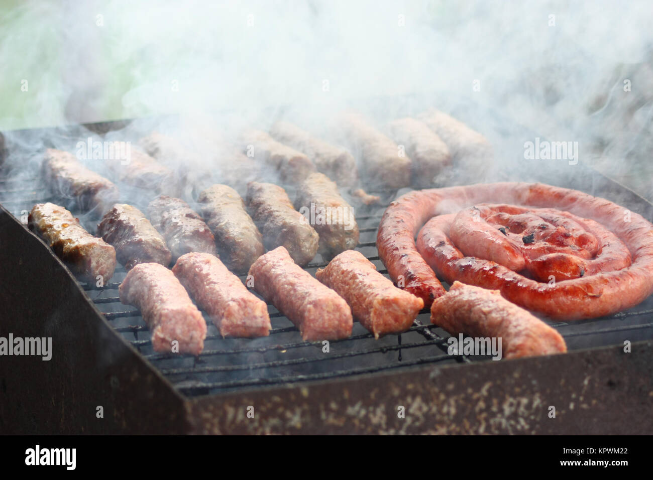 Barbecuing meat on charcoal fire closeup image Stock Photo - Alamy