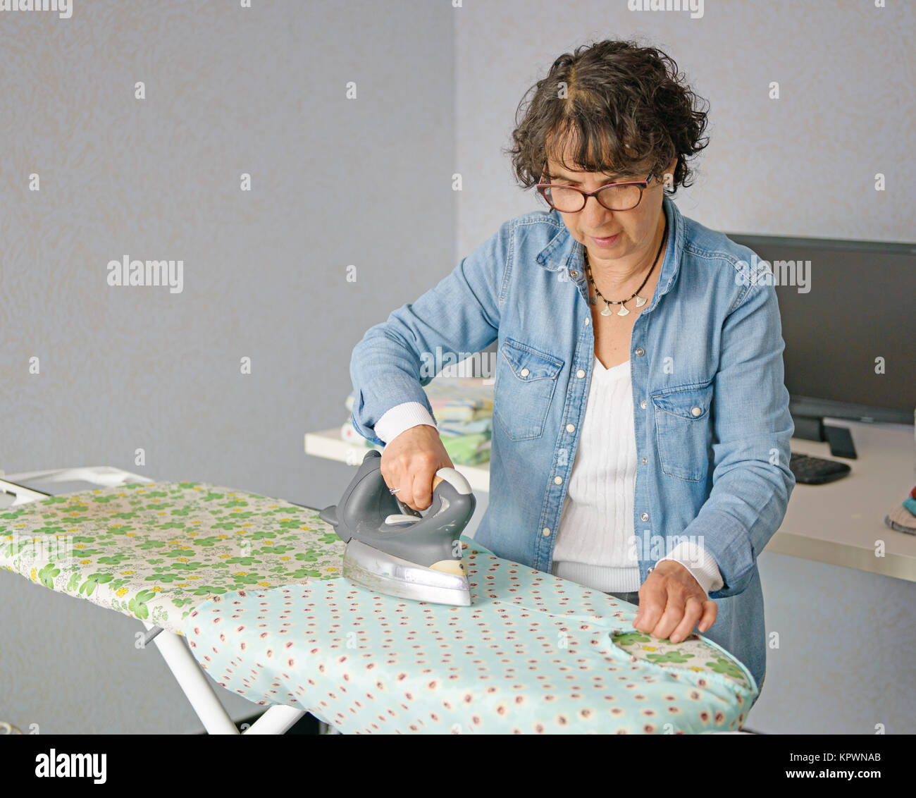 charming woman doing the ironing Stock Photo - Alamy
