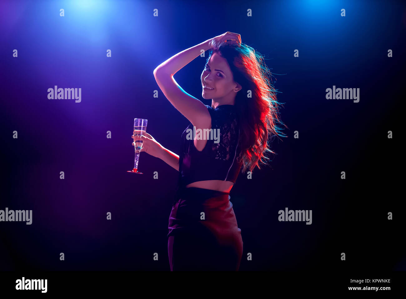 The beautiful girl dancing at the party drinking champagne Stock Photo ...