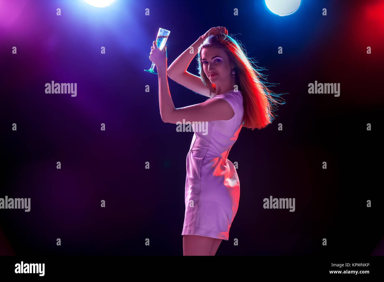 The beautiful girl dancing at the party drinking champagne Stock Photo ...
