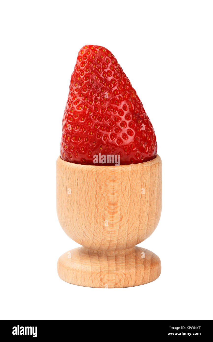 One red mellow strawberry in eggcup over white Stock Photo - Alamy