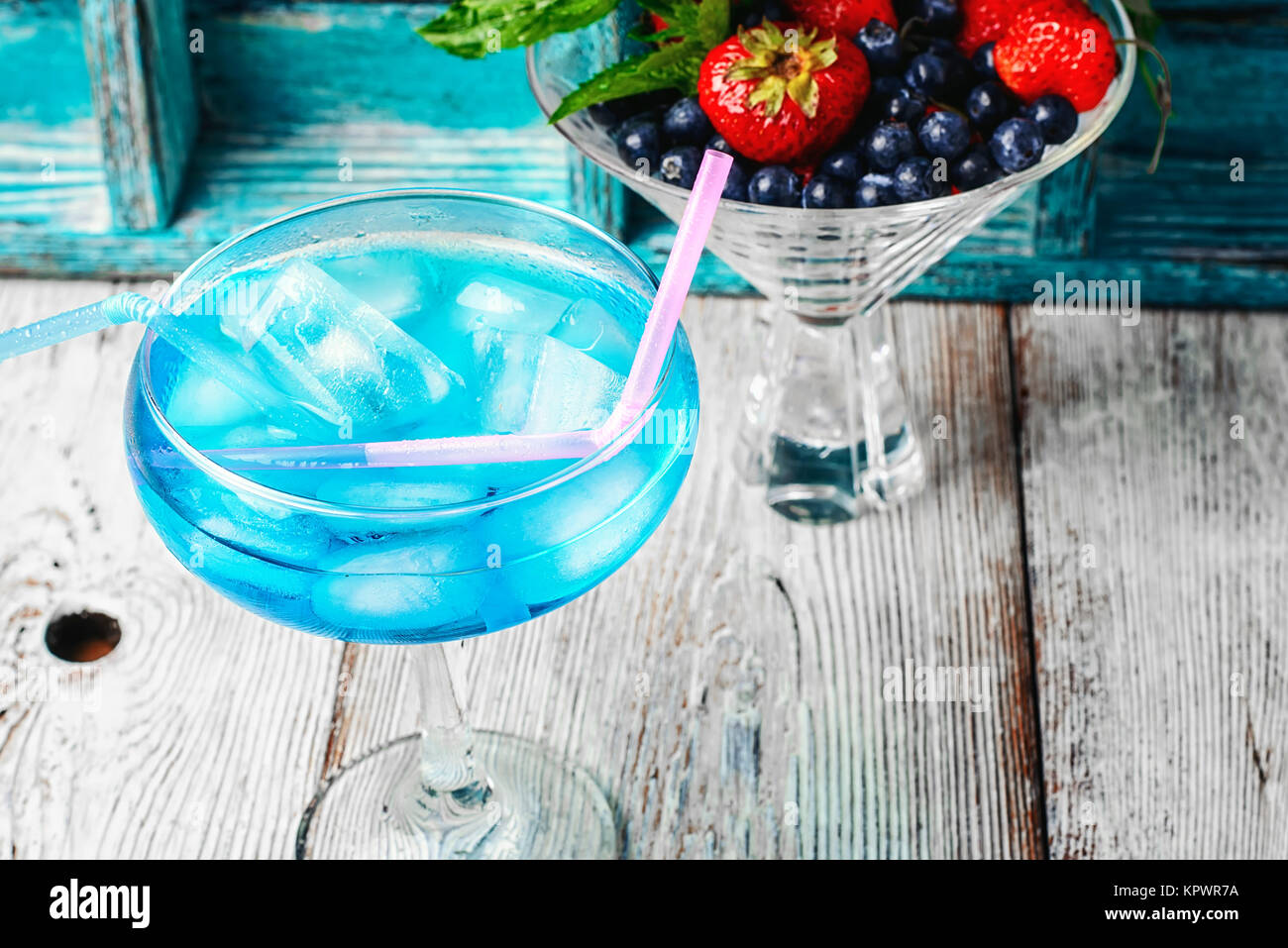 Alcohol in stylish blue color glass glass on long stalk Stock Photo - Alamy
