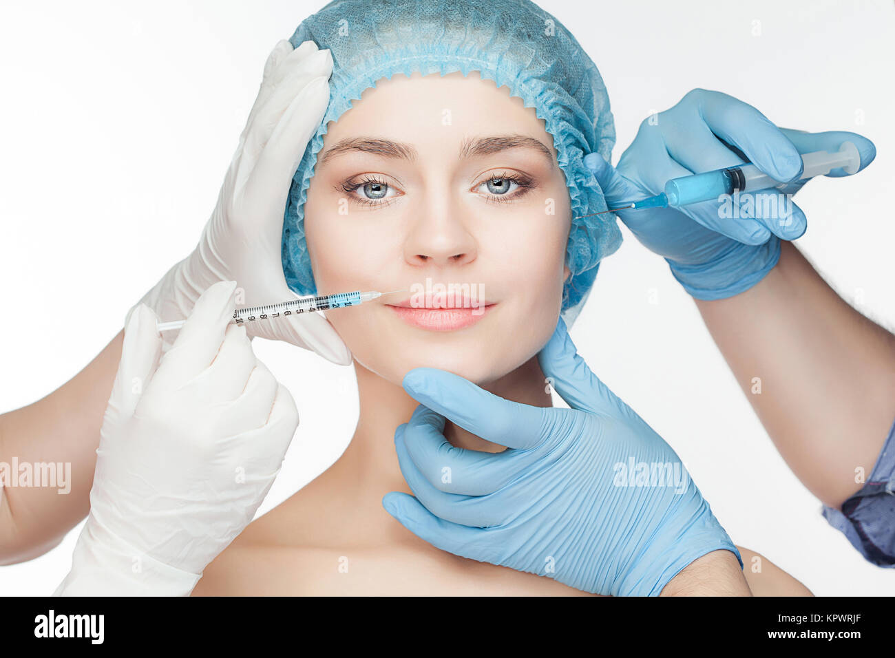 Attractive woman at plastic surgery with syringe in her face Stock ...
