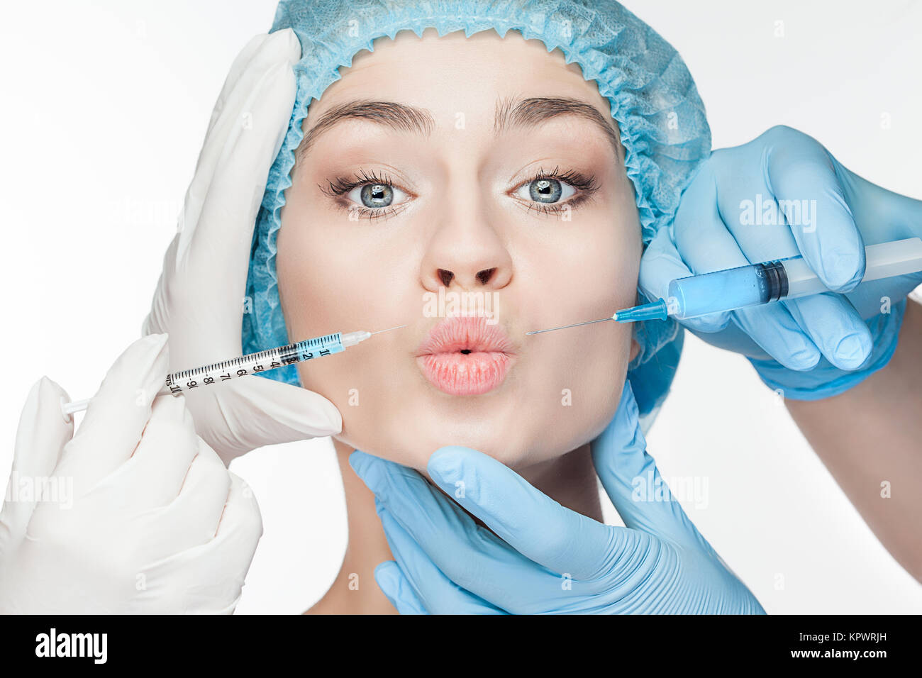 Attractive woman at plastic surgery with syringe in her face Stock ...
