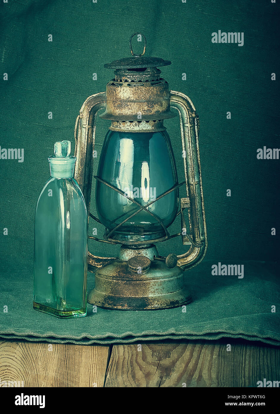 Rusty kerosene lamp and a bottle of kerosene Stock Photo - Alamy