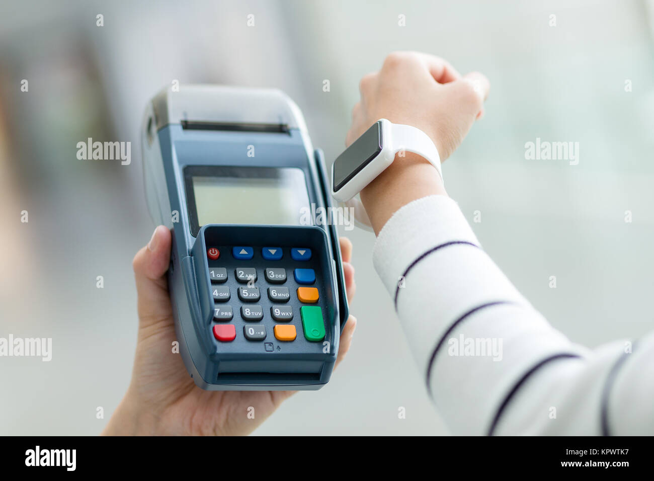 Woman pay by smartwatch with NFC Stock Photo - Alamy