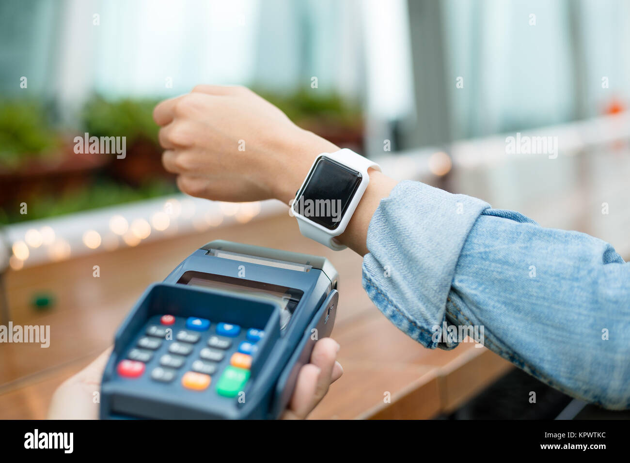 Customer using smart watch to pay Stock Photo - Alamy