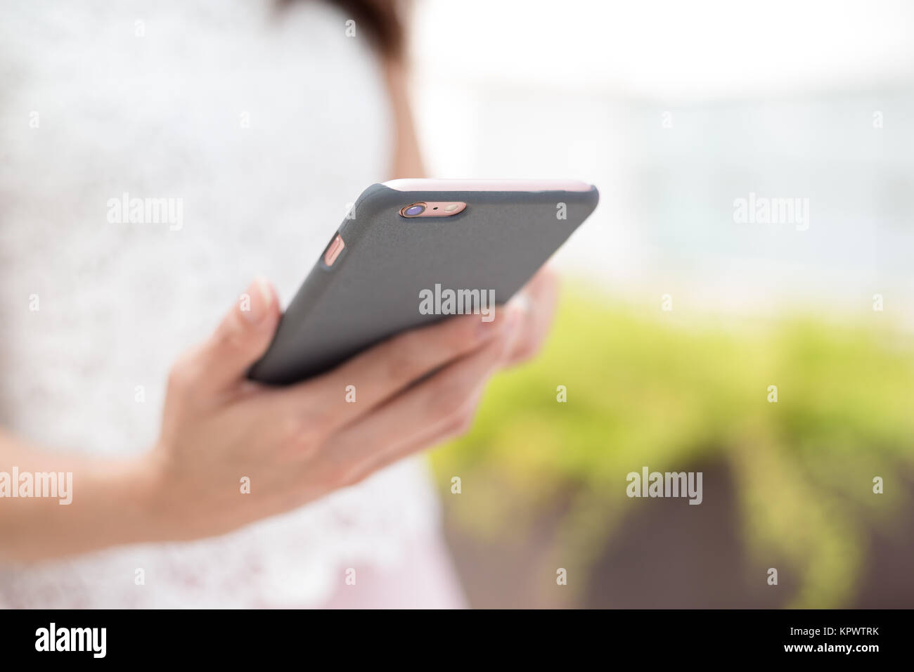Woman holding on mobile phone Stock Photo - Alamy